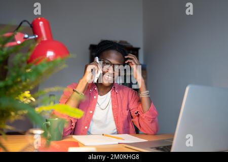 Friendly young African man freelance consultant talking to client on ...