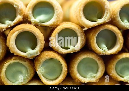 Crispy Italian Cannoli with sweet light green fillings Stock Photo - Alamy