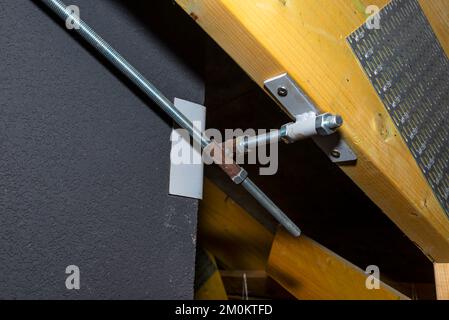 Steel fixing of the ceramic chimney to the trusses inside the attic ...