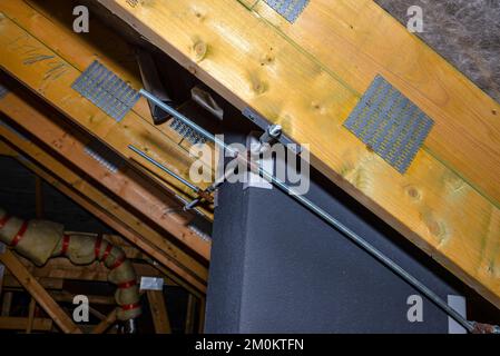 Steel fixing of the ceramic chimney to the trusses inside the attic ...