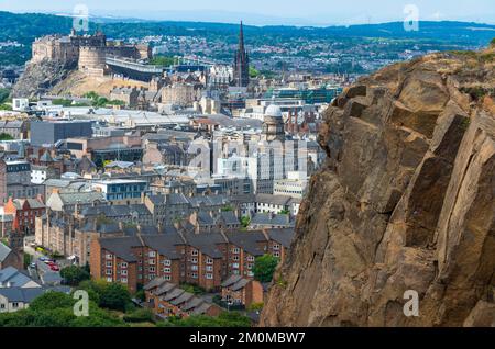 Rocky cliffs in the foreground,dominate the Scotland's capital city ...
