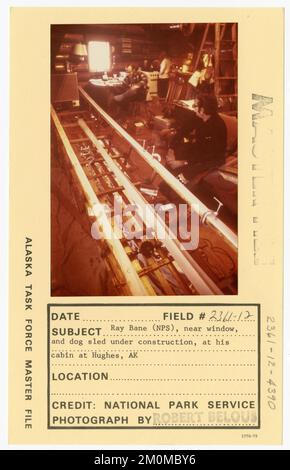Ray Bane (NPS), near window, and dog sled under construction, at his ...