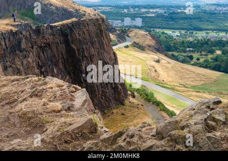 Looking down to pathways of Holyrood Park far below.narrow paths across ...