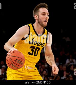Iowa guard Connor McCaffery (30) passes the ball as he is defended by ...