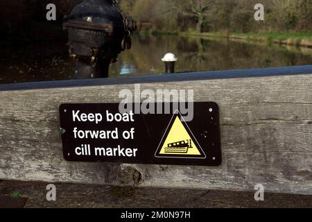 Warning sign 'Keep boat forward of cill marker' on a UK canal lock gate ...