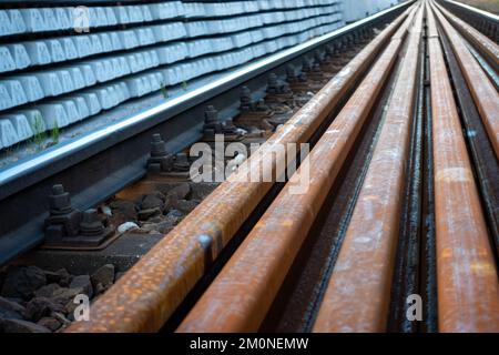Expansion of railway lines. Train rails ready for laying and concrete ...