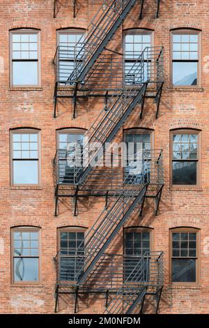 Red Metal Fire Escape on Old Brick Building Stock Photo - Alamy