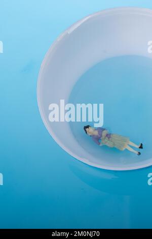 Little model globe floating in blue water Stock Photo - Alamy