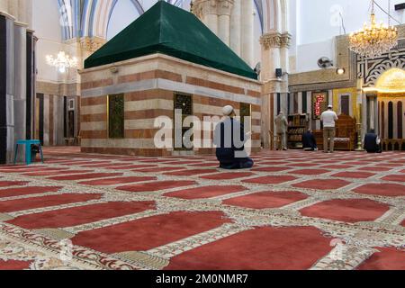Muslim visitors praying in Abraham Mosque of Hebron. Tombs of Isaac and ...