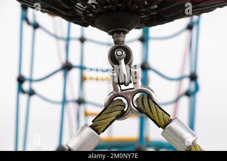 Children's rope swing with fasteners close-up, connecting part with a ...
