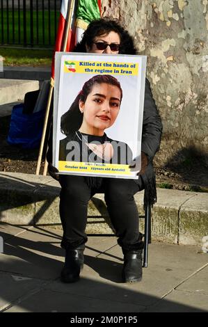 Activist holding a portrait of Asra Panahi who was killed during the ...