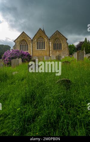 The church of St Mary. The Virgin at Westerham Kent. With storm clouds ...