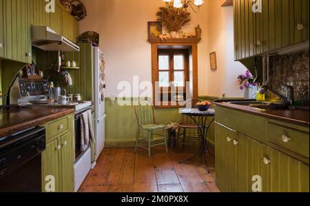 Kitchen room with olive green cabinets inside old 1850 Canadiana ...