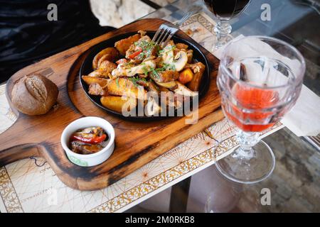 Hot frying pan with meat potatoes and mushrooms Stock Photo - Alamy