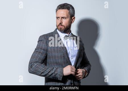 charismatic guy wear tuxedo formal suit. guy in tuxedo on grey ...