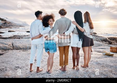 Group of happy male friends huddling, looking down at camera, smiling ...