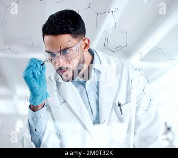 Young hispanic man scientist writing on notebook measuring liquid at ...