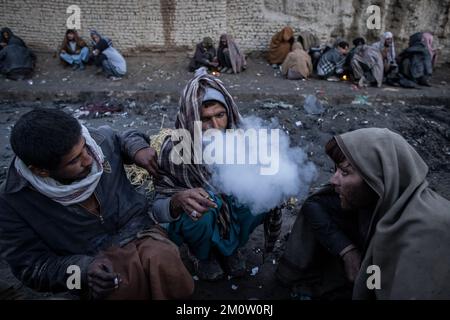 Kabul, Afghanistan. 14th Nov, 2022. Afghan men consume drugs on a side ...