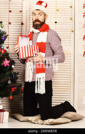 Guy stands by Christmas tree. Santa Claus with cheerful face Stock ...