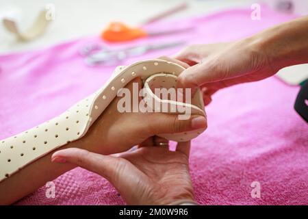 Therapist making assistive device for immobilize patient hand. Splint ...