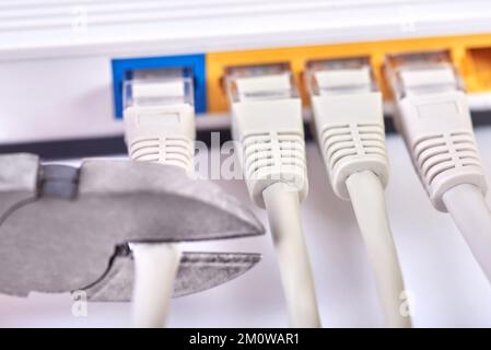 Wire cutters cuts the Internet cable into the router Stock Photo - Alamy