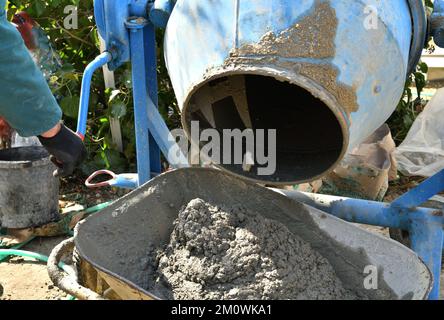 A Mason makes concrete using a concrete temperer traditionally Stock ...