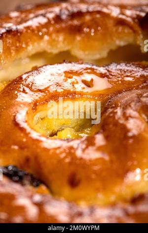 Macro shot of a pain aux raisins on a reflecting surface. Selective ...