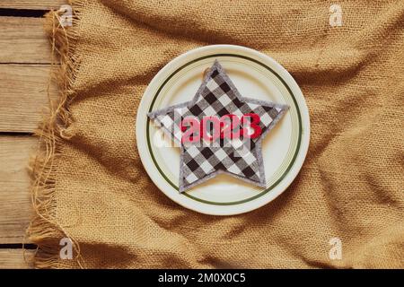 Happy January typography text decorate with flower on wooden background ...