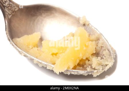 Ghee in spoon isolated on white background Stock Photo - Alamy