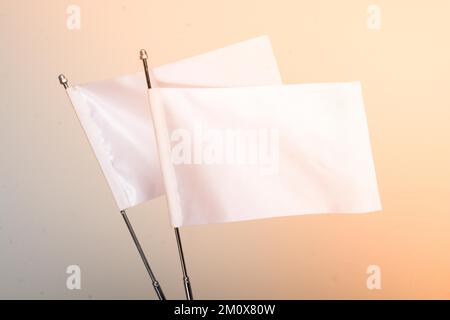 Two white flags on a white background in the display Stock Photo - Alamy