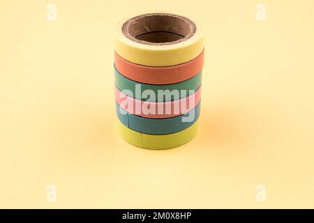 Color ribbon tapes on a yellow background Stock Photo - Alamy