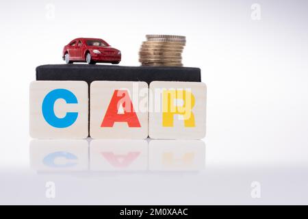 Colorful little toy cars and coins on white background Stock Photo - Alamy