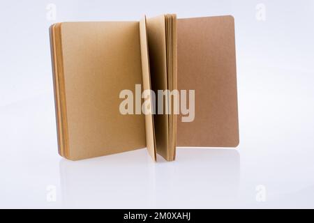 Brown color notebook with open pages on a white background Stock Photo ...