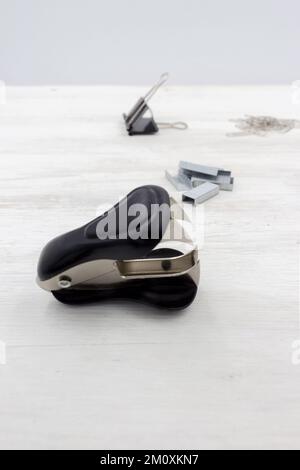 Stapler and anti-stapler with staples on a white background. Office ...