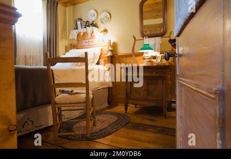 Antique rocking chair next to single bed in guest bedroom inside 1977 ...