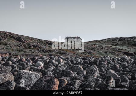 Gloomy view of an abandoned house amid desolation. Rybachy Peninsula ...