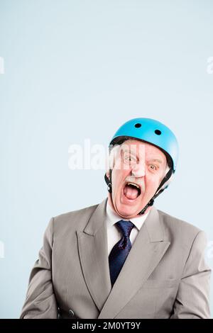 Senior business man studio standing isolated on gray wall holding ...