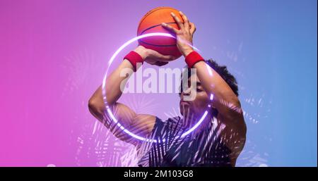 Composite of biracial basketball player throwing ball by illuminated ...