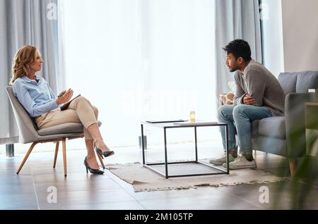 Young hispanic man psychologist having therapy session using touchpad ...
