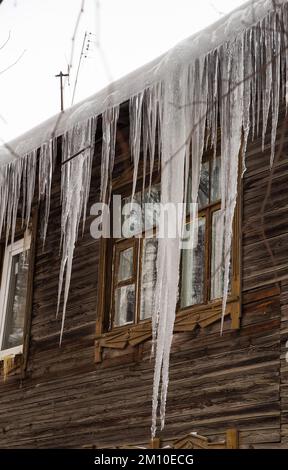 Icicles on an old window Stock Photo - Alamy