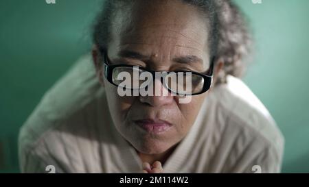 Religious older senior hispanic woman praying to God. Spiritual South ...