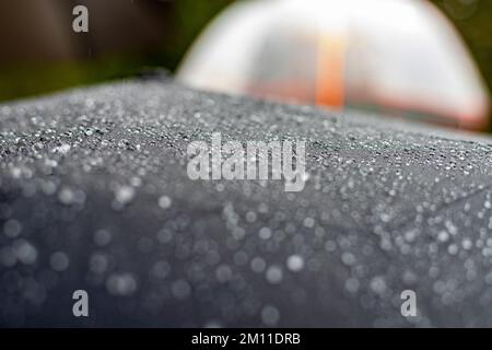 Rain. Raindrops on an umbrella forming precipitation balls. Abstract ...