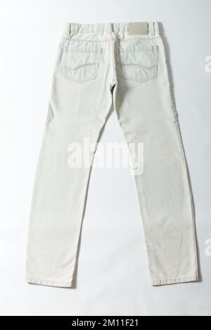 Ice blue colored jeans on a white background Stock Photo - Alamy