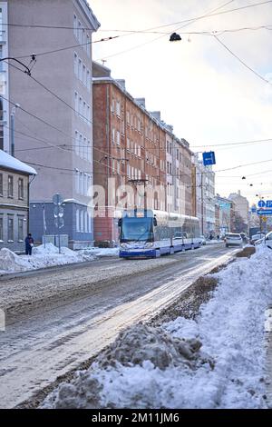 Riga, Latvia - December 8, 2022: Modern tram and cars on the snowy ...