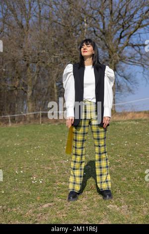 woman dressed in white enjoying the sand dunes on a sunny spring or ...