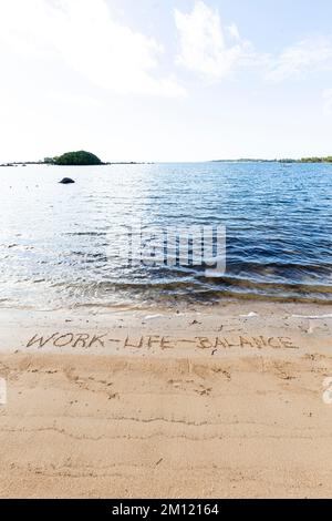 Life is a beach message written on white sand, with tropical sea waves ...