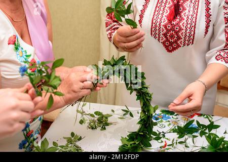 The process of weaving a periwinkle wreath, which is a traditional ...