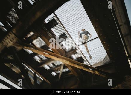 man, jogging, from below, grid Stock Photo - Alamy