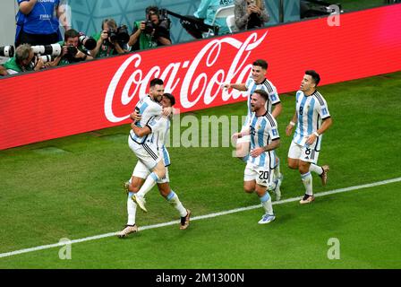 Argentina's Lionel Messi (left) and Nahuel Molina celebrate following ...