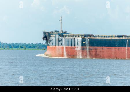 Cargo ships travelling along the Amazonas river in Brazil along the ...